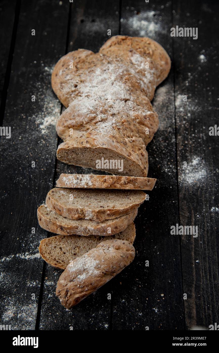 A long loaf of flax seed wholemeal bread, sliced Stock Photo - Alamy