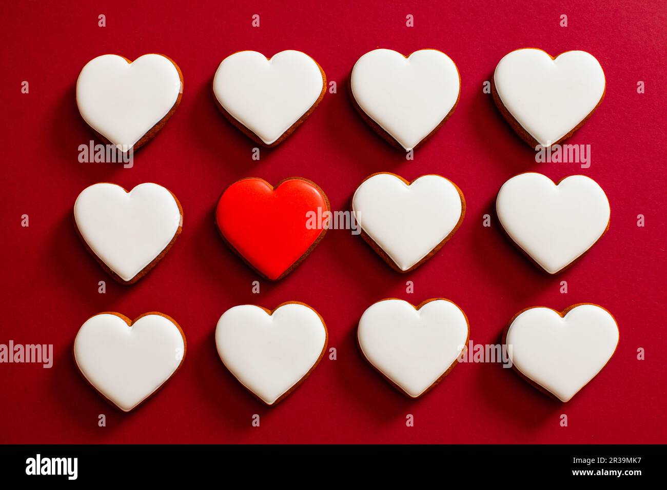 Valentines day concept. Red background with white heart shape cookies ...