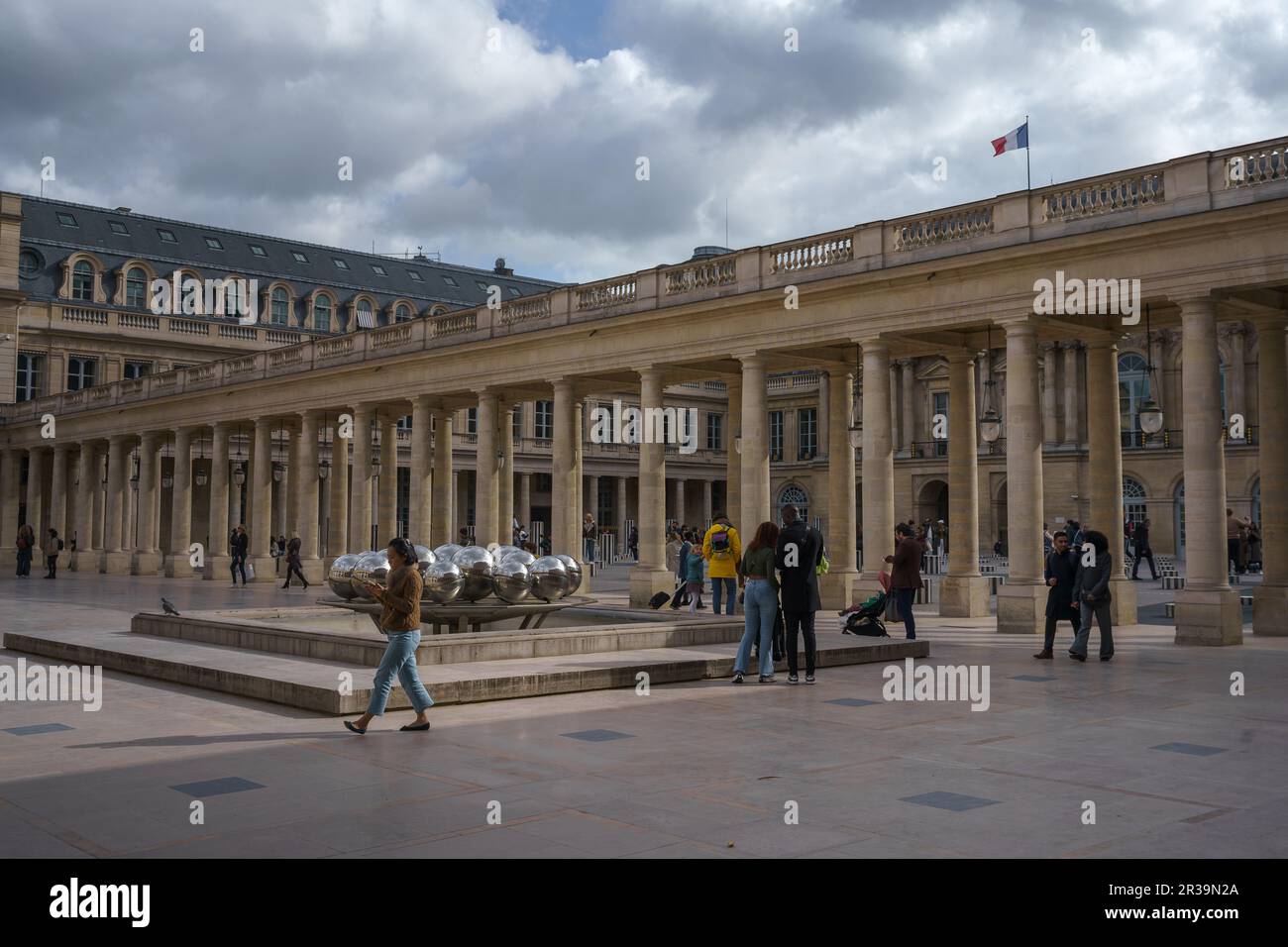 The Courtyard of Honor at the Palais-Royal in Paris, France with people ...