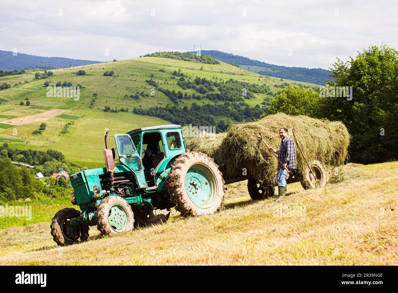 Tractor harvesting hay in hi-res stock photography and images - Alamy