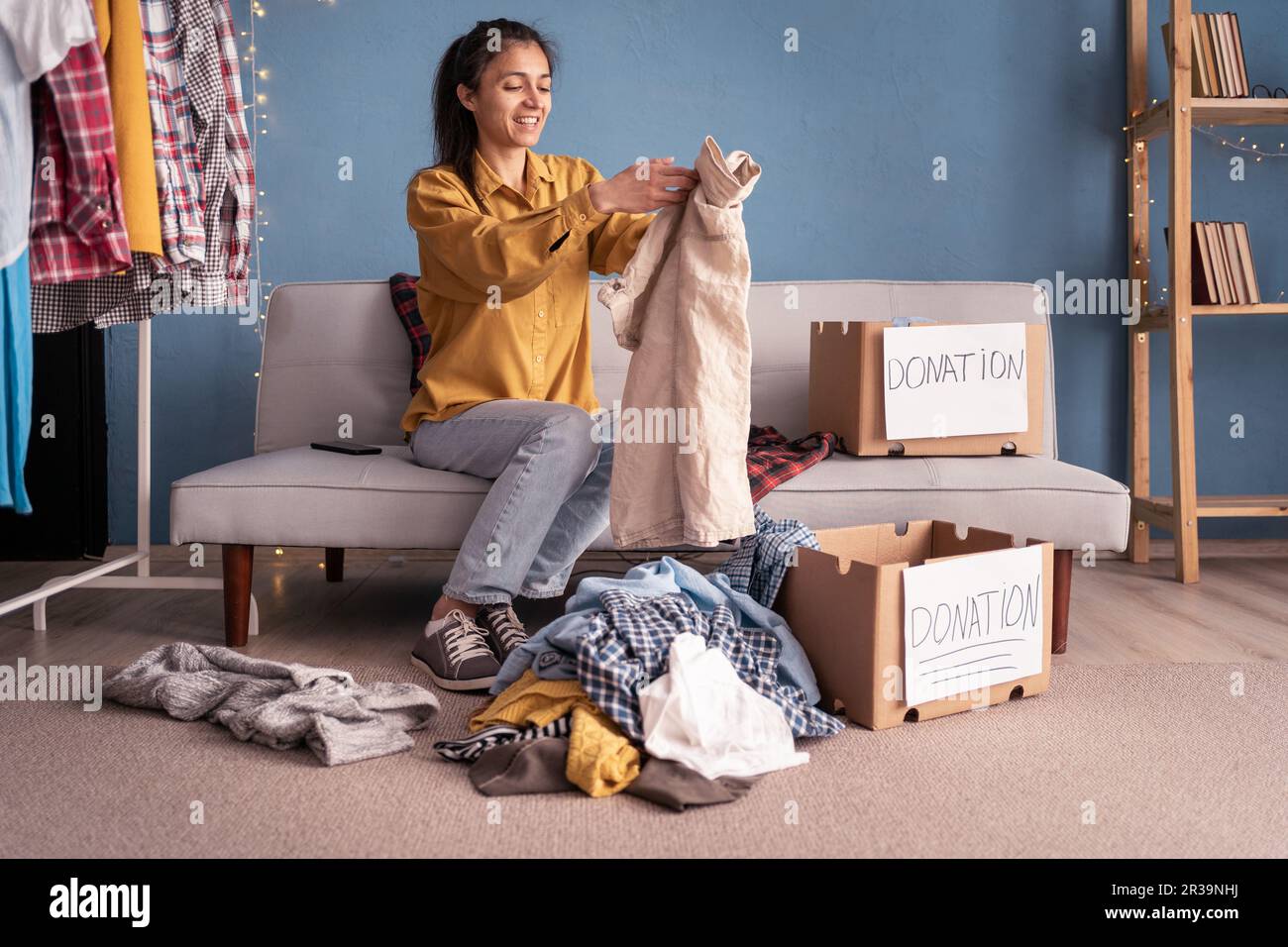 Woman packs donation box clothes hi-res stock photography and images ...