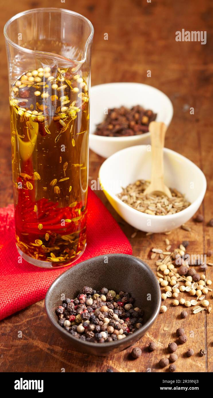 Homemade savory spice oil in a glass carafe Stock Photo - Alamy