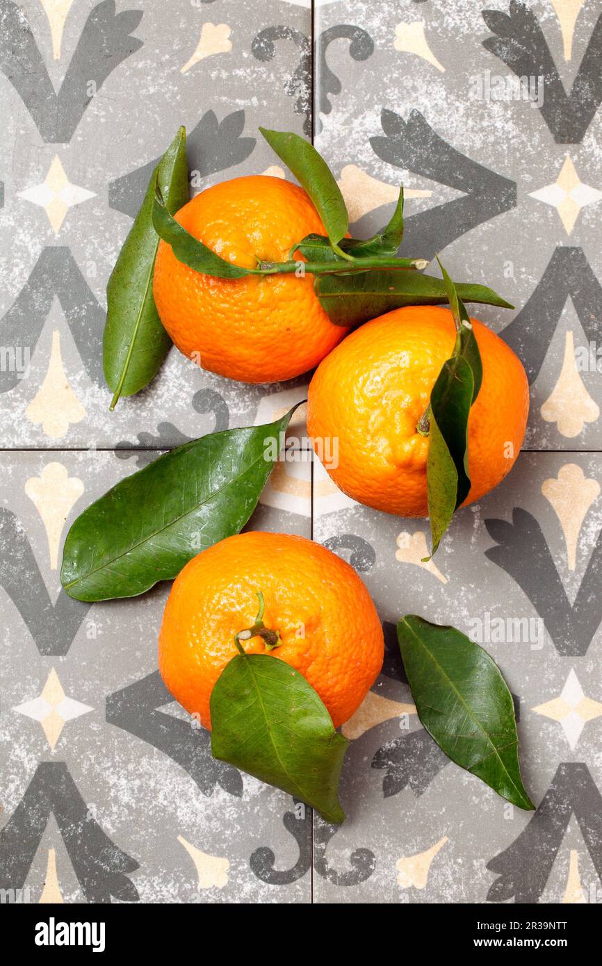 Three fresh mandarins with leaves Stock Photo - Alamy