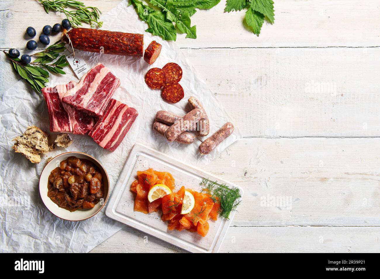 Mixture of raw meat, cured sausage, smoked salmon, and beef stew with ...