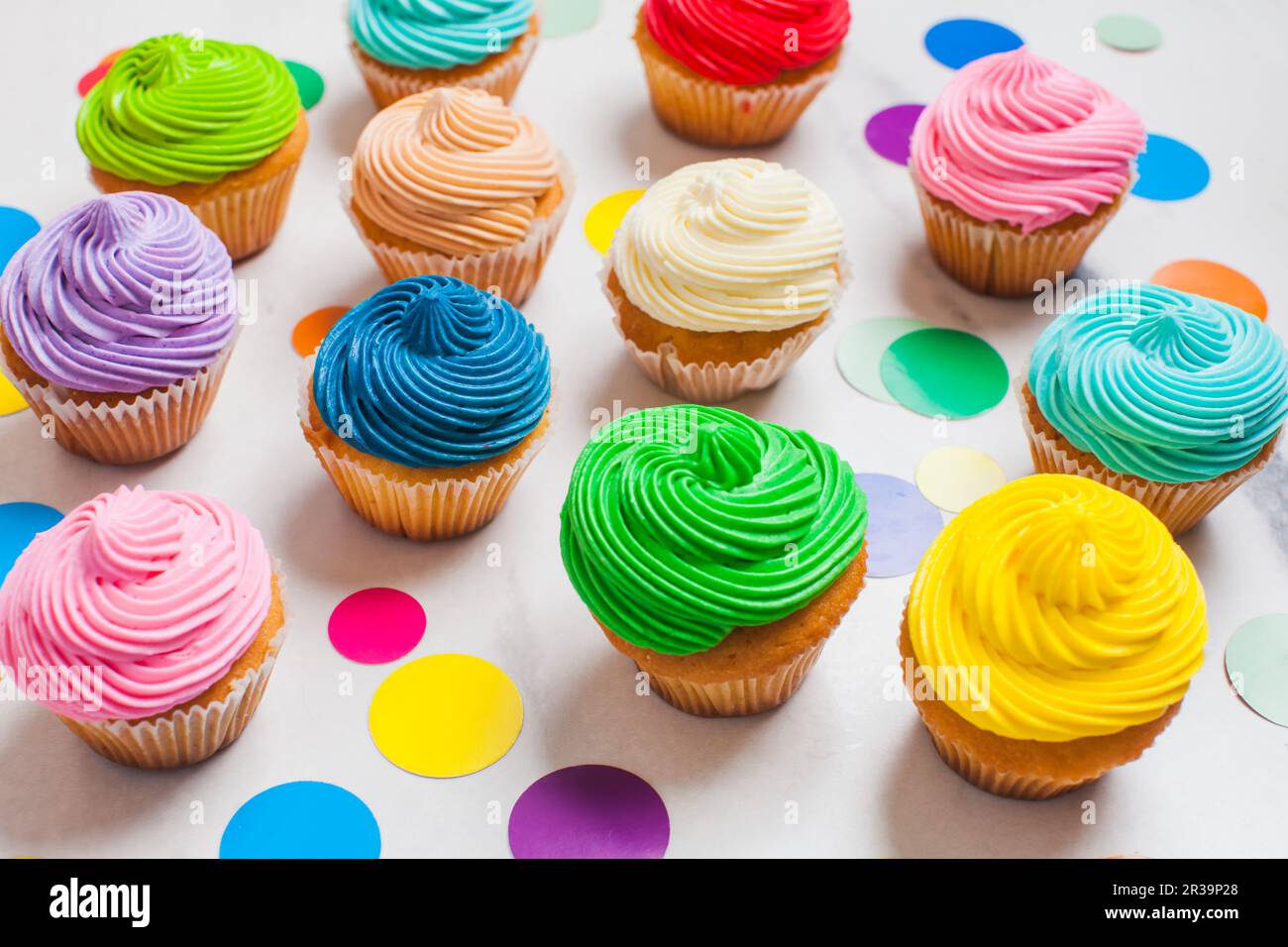 Colorful cupcakes on a white background with colorful dots Stock Photo ...