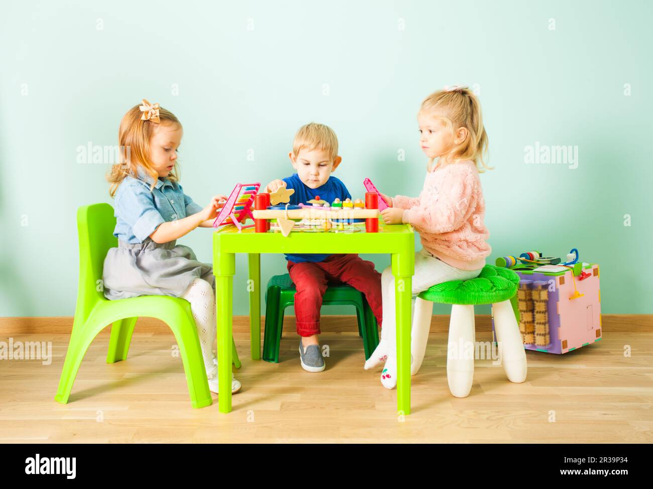 Cute little children playing in kindergarten room Stock Photo - Alamy