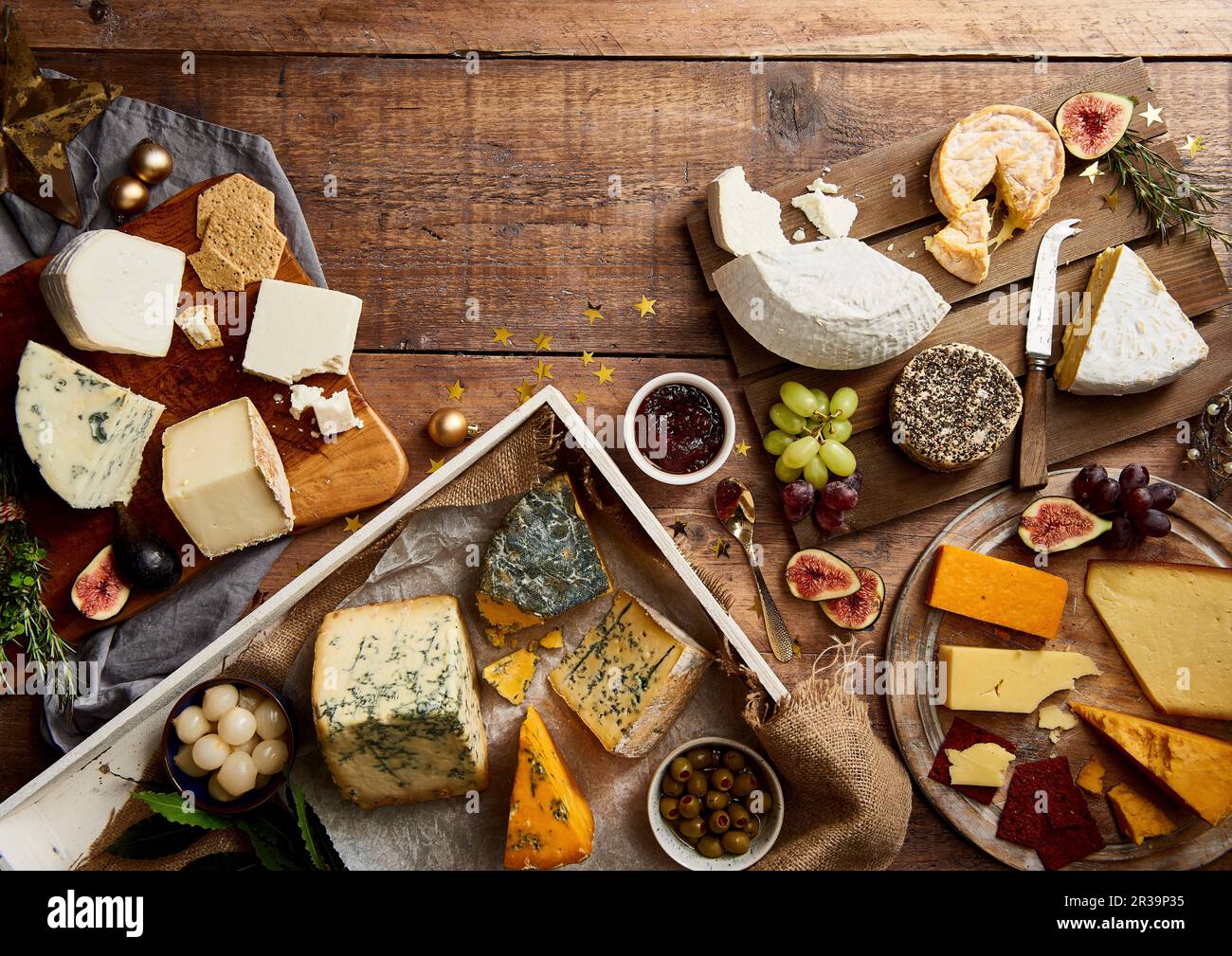 Selection of cheeses with fruit, crackers, herbs and chutney Stock ...