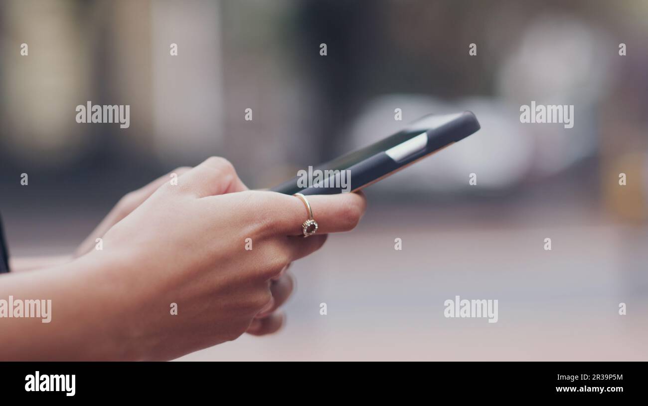 Woman, hands and searching phone with city background for texting ...