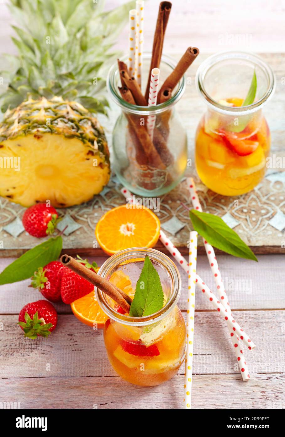 Summer pineapple rum punch with strawberries, mandarins and cinnamon ...
