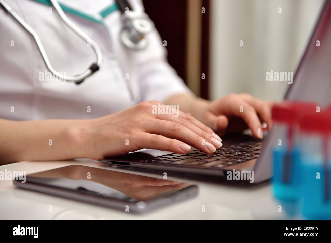 Doctor hands typing on laptop with X-rays of the spine on screen Stock ...