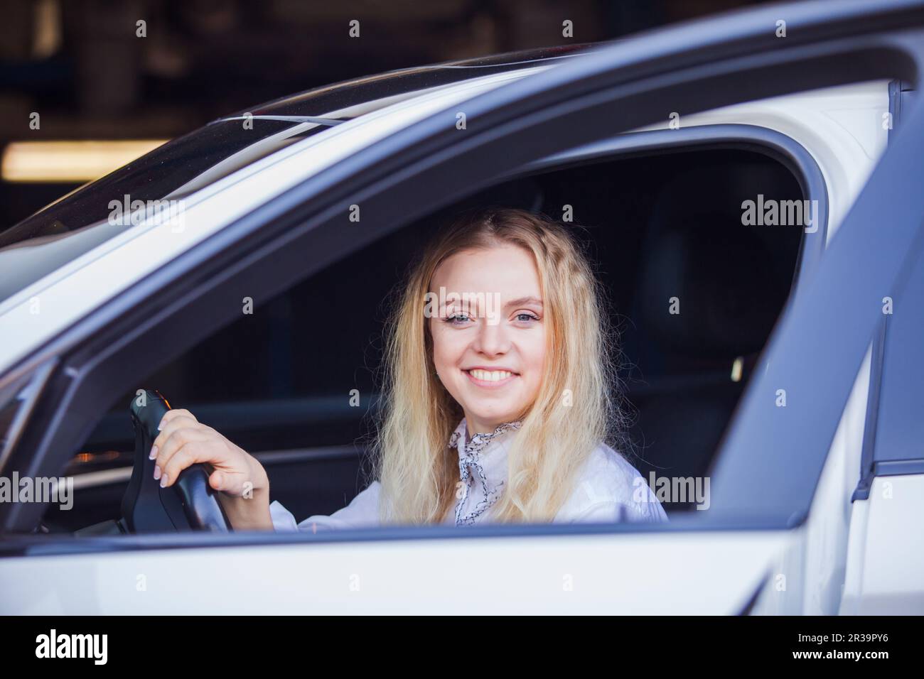 Woman driver siting in white car, smiling Stock Photo - Alamy
