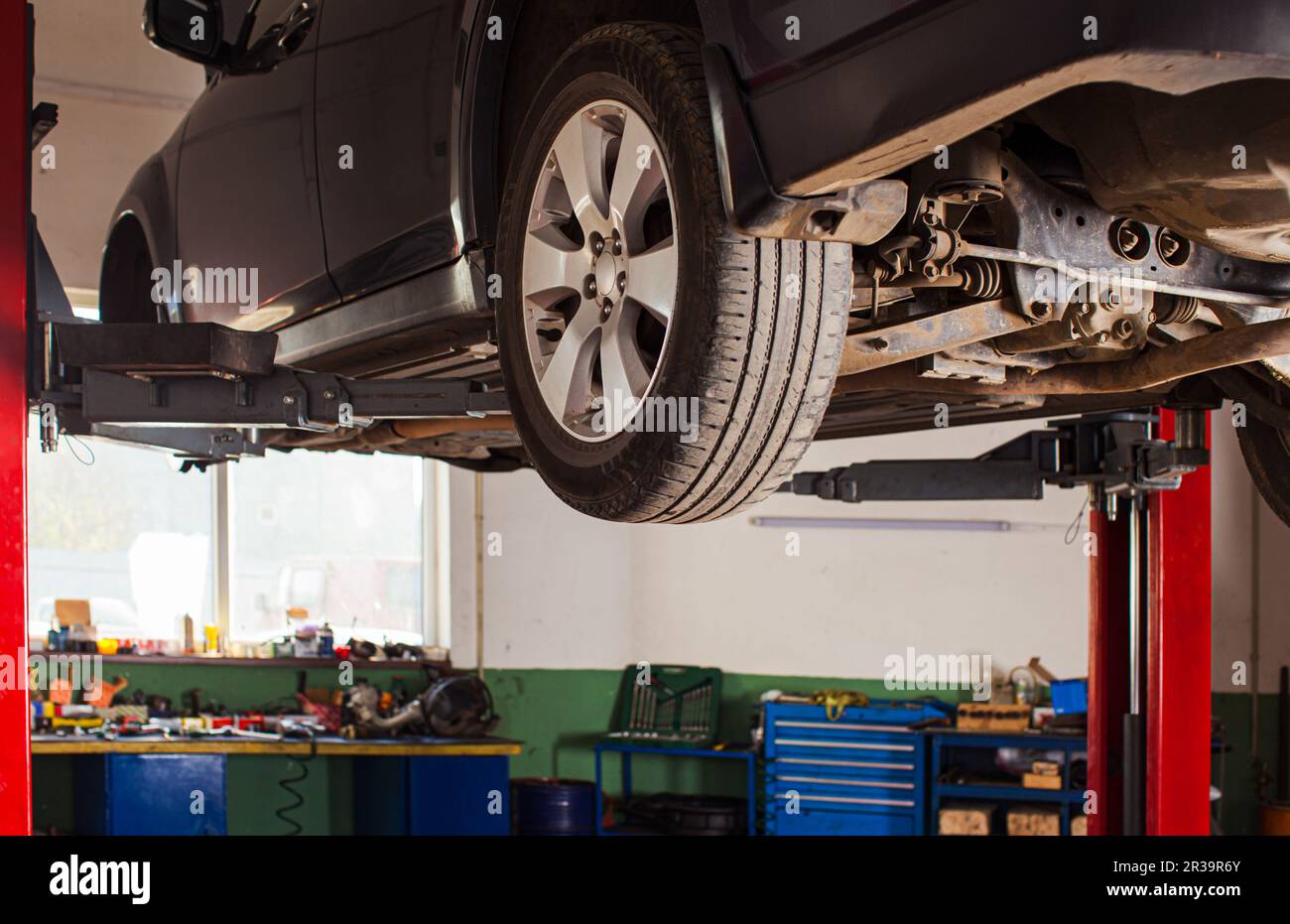 Car undergoing repair or a service in a workshop Stock Photo - Alamy