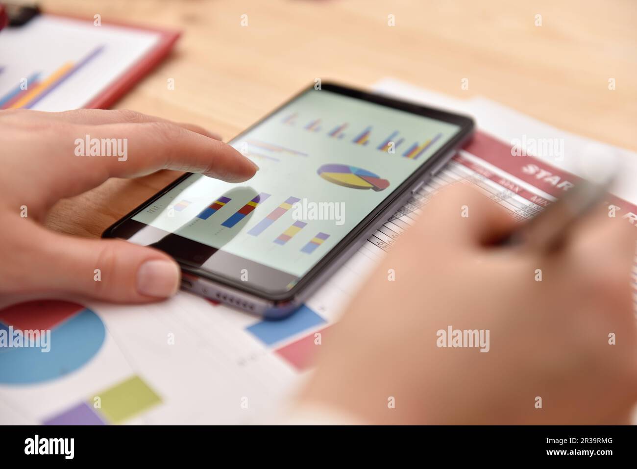 Smart phone with financial data in form of charts and diagrams. Close ...