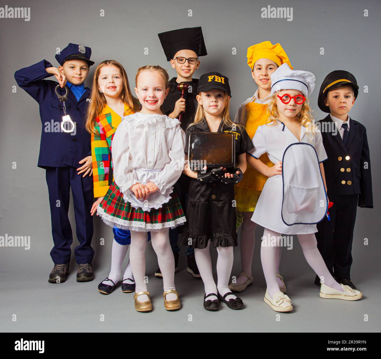 Happy friends dressed as doctor, cook, judge, policeman, agent fbi and ...