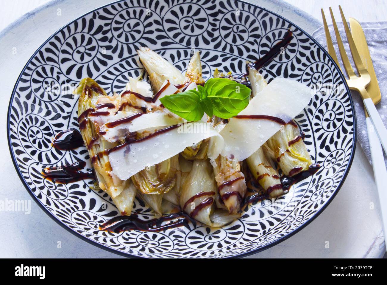 Roasted chicory with aceto balsamico and shaved Parmesan Stock Photo ...