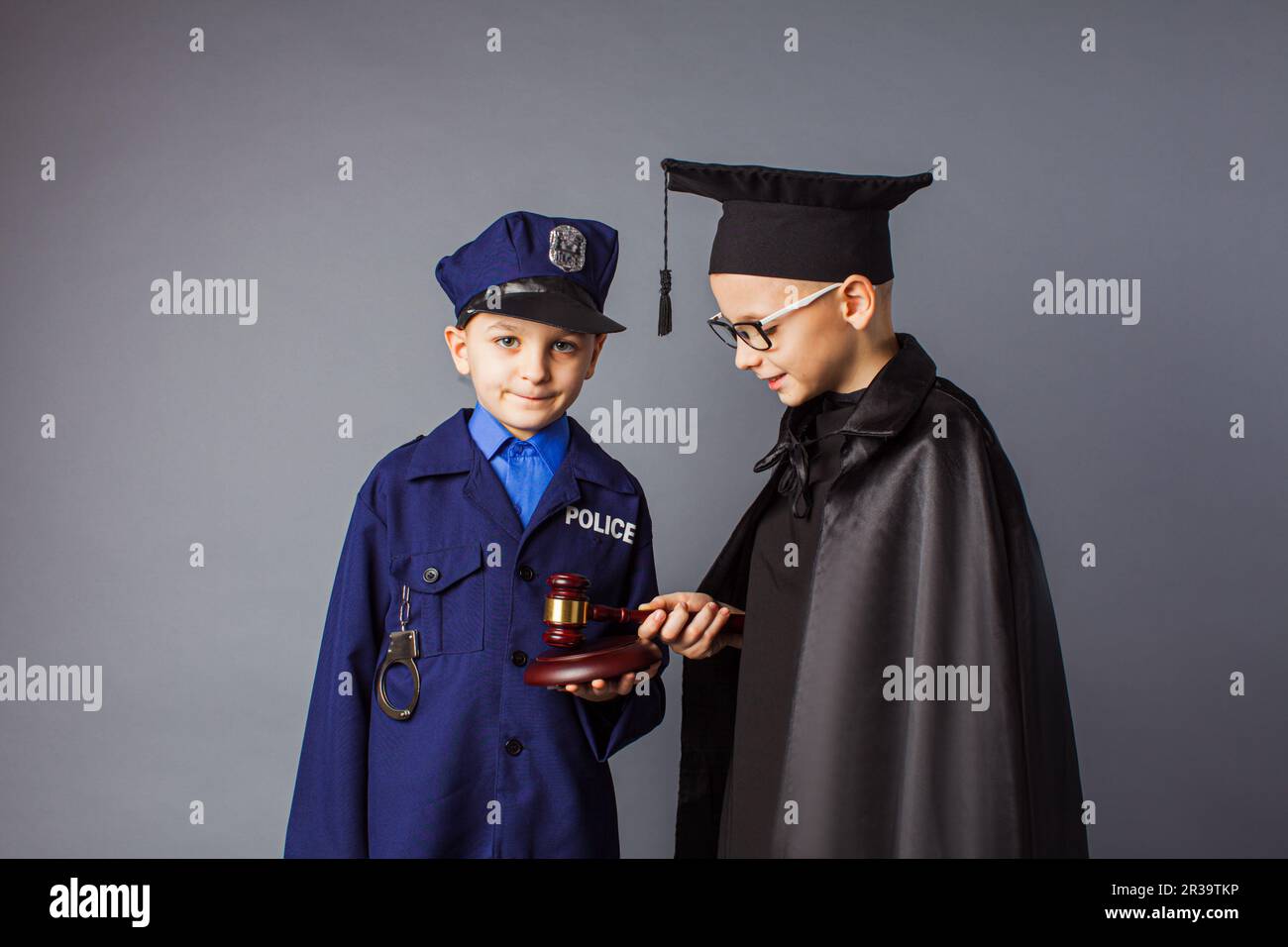 Children in costume of policeman and judge. Boys dream about future ...