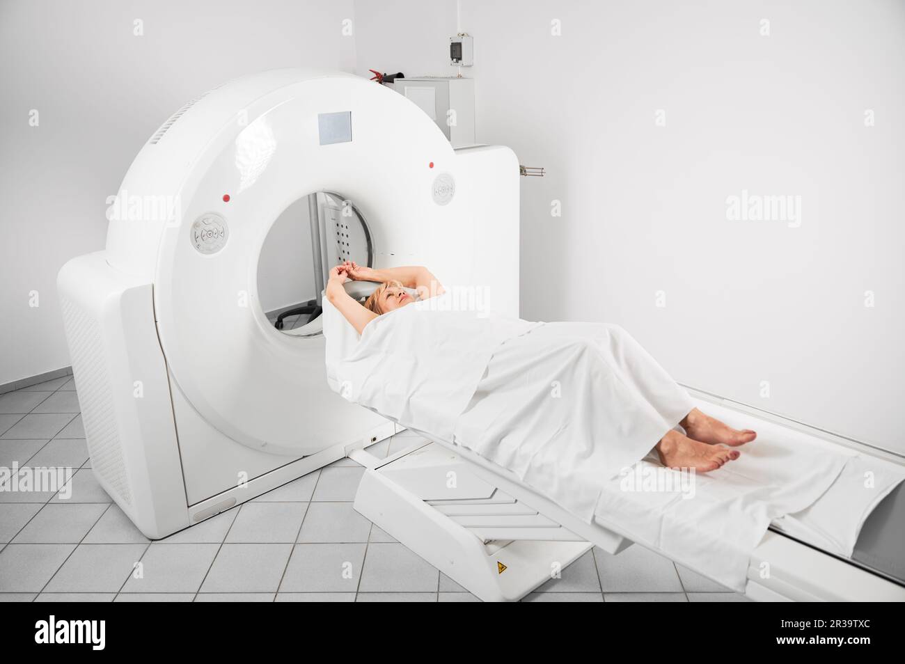 Medical computed tomography or MRI scanner. Woman patient lying on ...