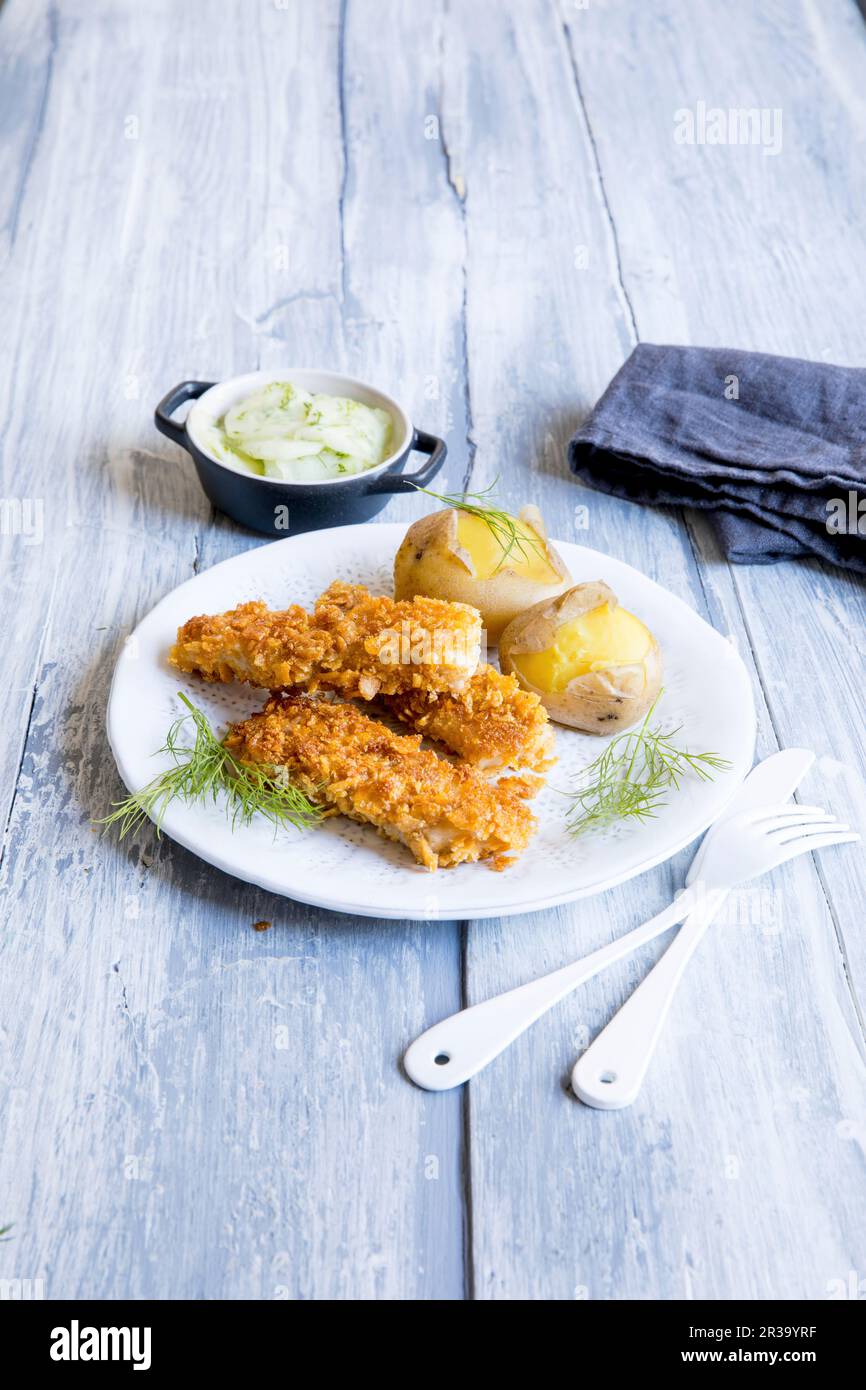 Homemade fish fingers with jacket potatoes Stock Photo - Alamy
