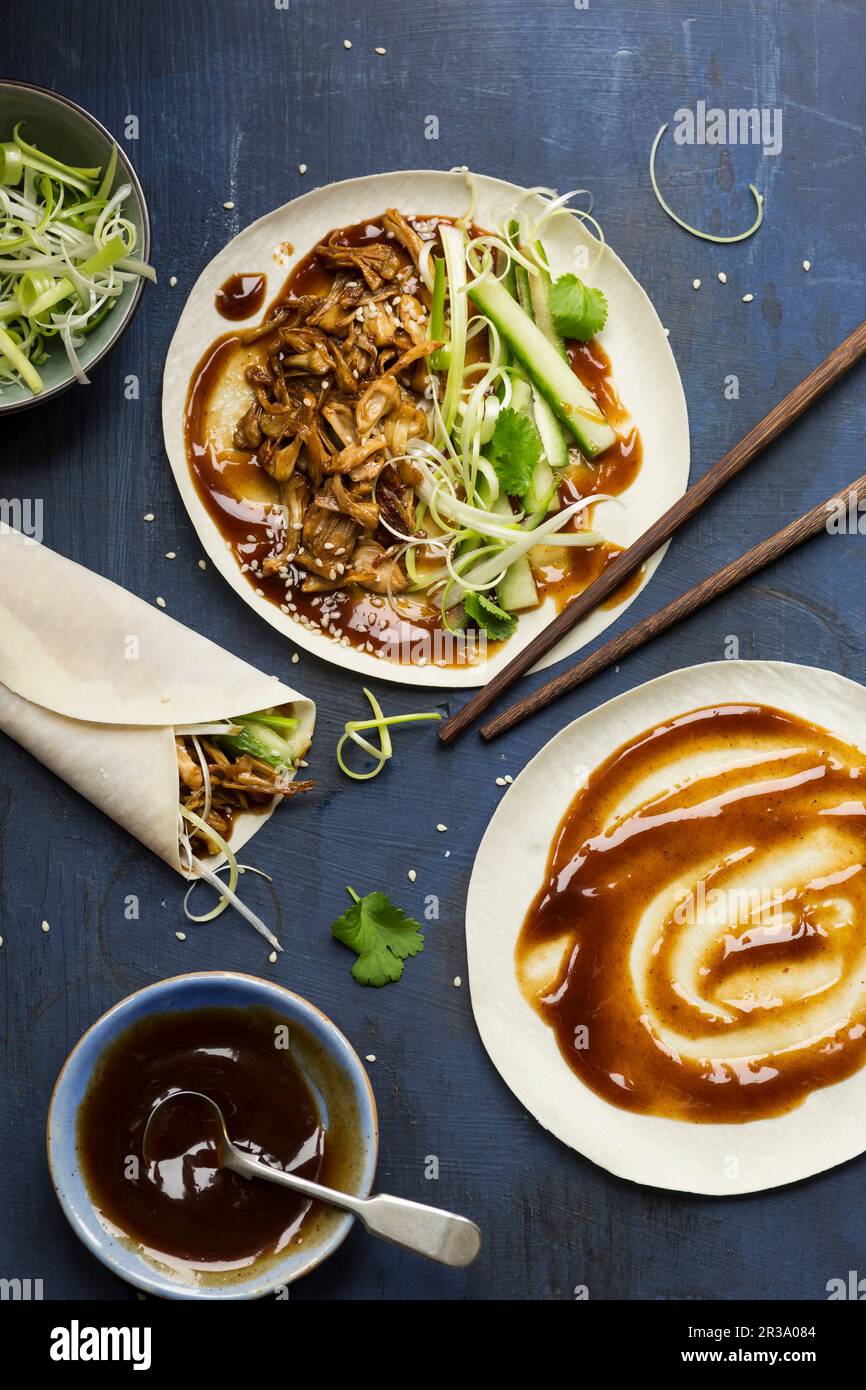 Vegan Chinese Jackfruit 'duck style' pancakes being made on a dark blue ...