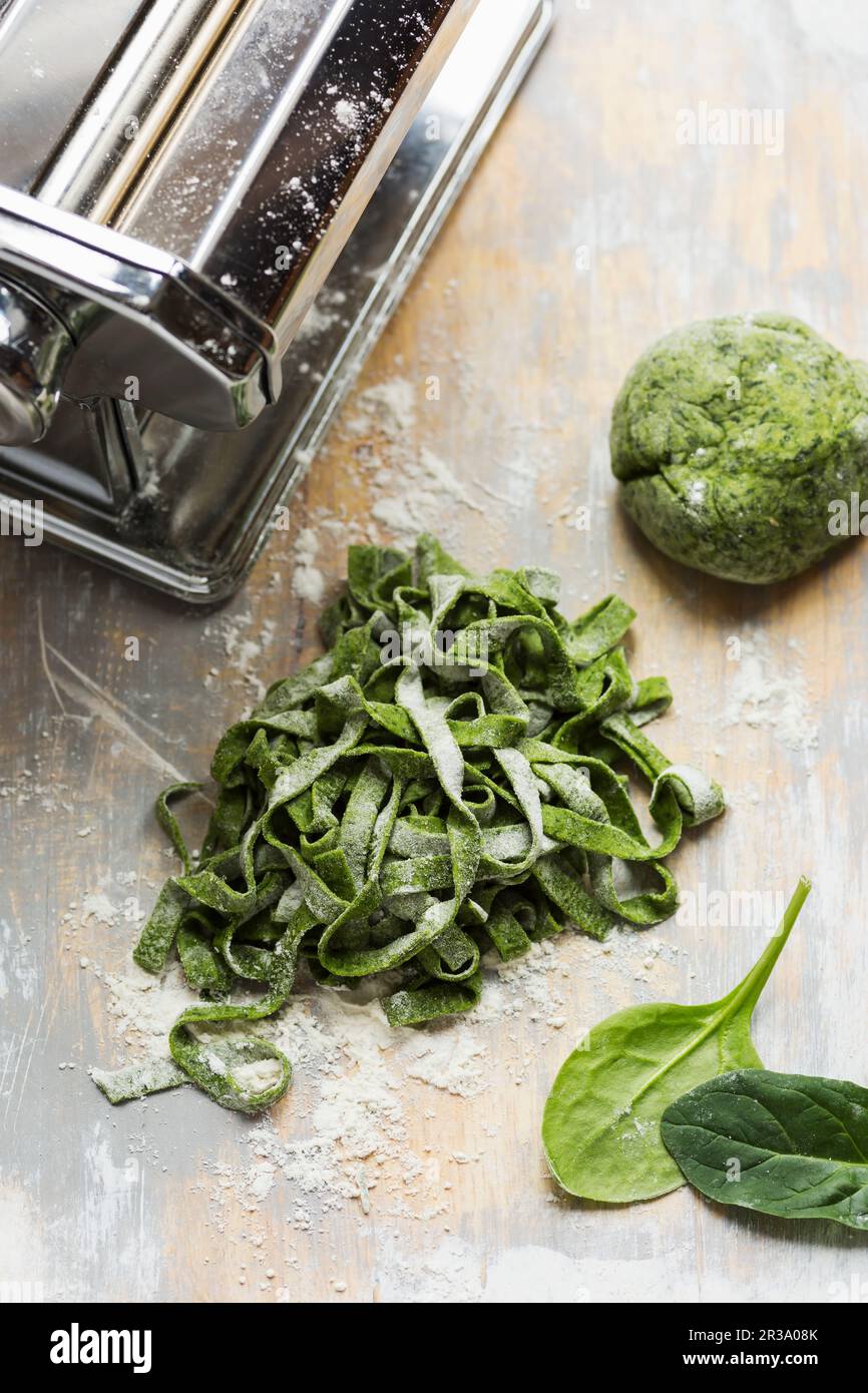 Spinach pasta dough homemade cut into tagliatelle with dough and pasta ...