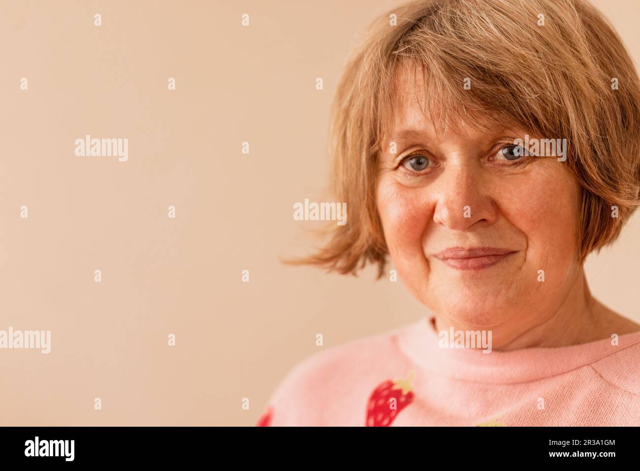 Close up portrait of senior mature woman in casual clothes on light ...