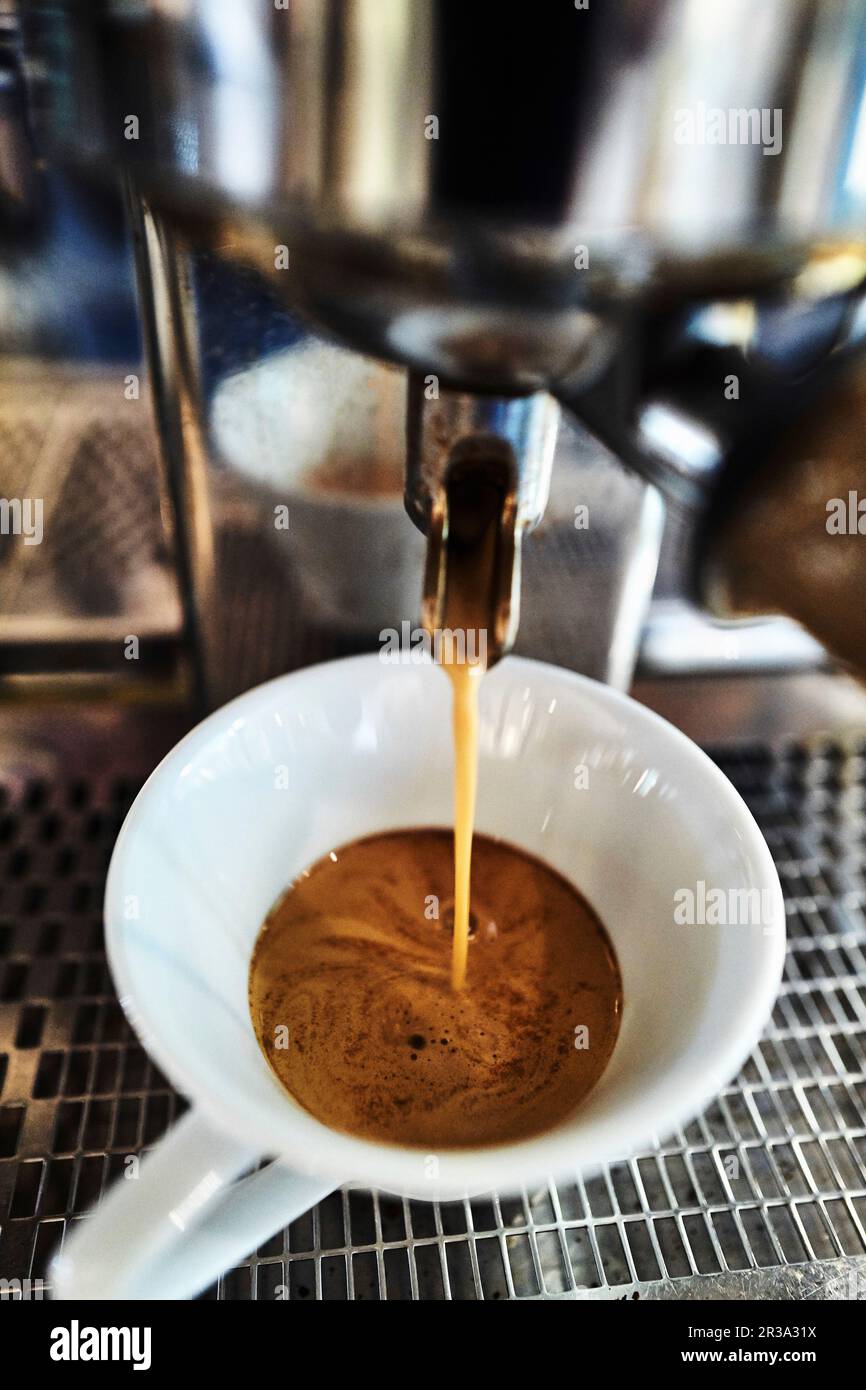 Coffee flowing from an espresso machine Stock Photo - Alamy