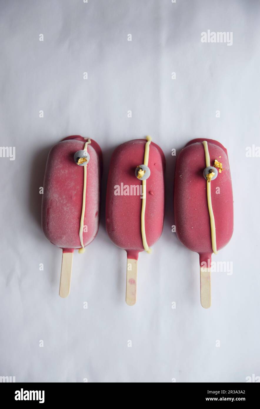 Three red ice cream sticks Stock Photo - Alamy