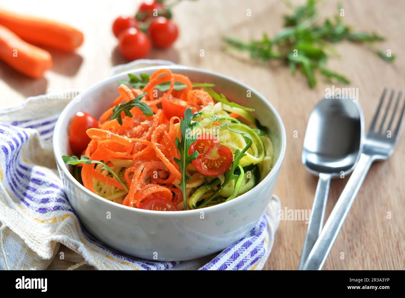 Vegetable spaghetti made with carrots and courgette, fresh tomatoes and ...
