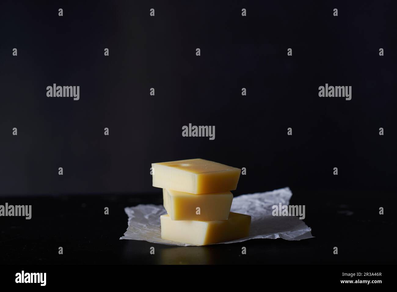 A stack of three slices of Emmental cheese Stock Photo - Alamy