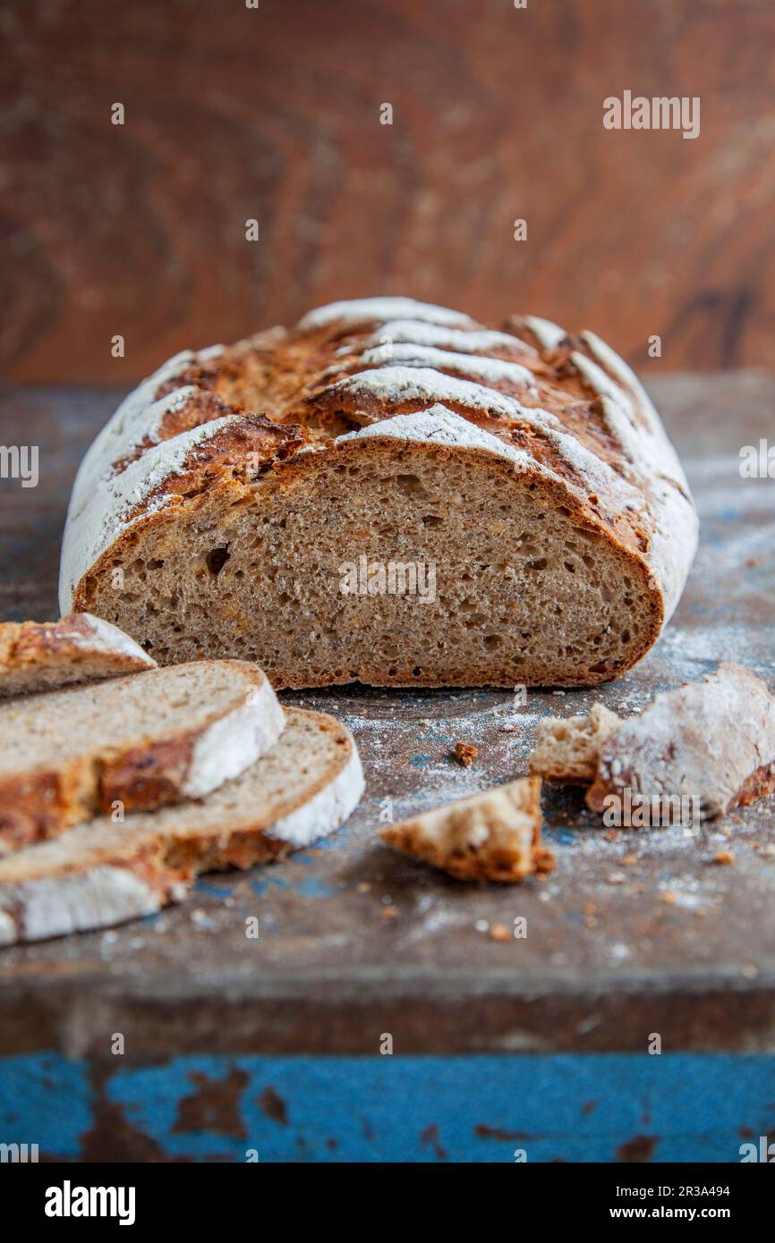 A long loaf of wholemeal sour dough bread, sliced Stock Photo - Alamy