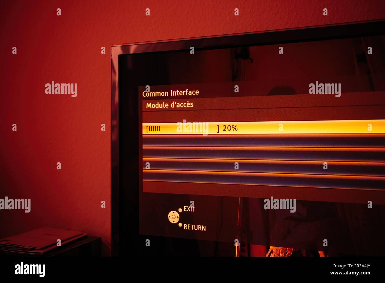 A modern TV screen displays urgent text in red, warning of the need to ...