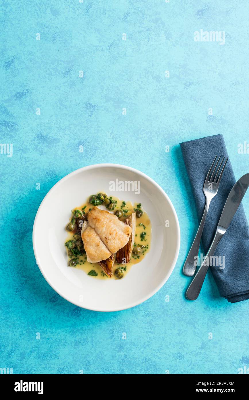 Fried fish with a caper sauce Stock Photo - Alamy