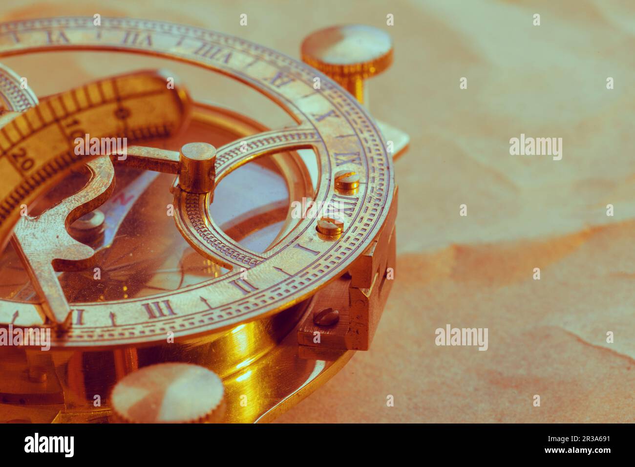 antique compass on vintage paper background Stock Photo - Alamy
