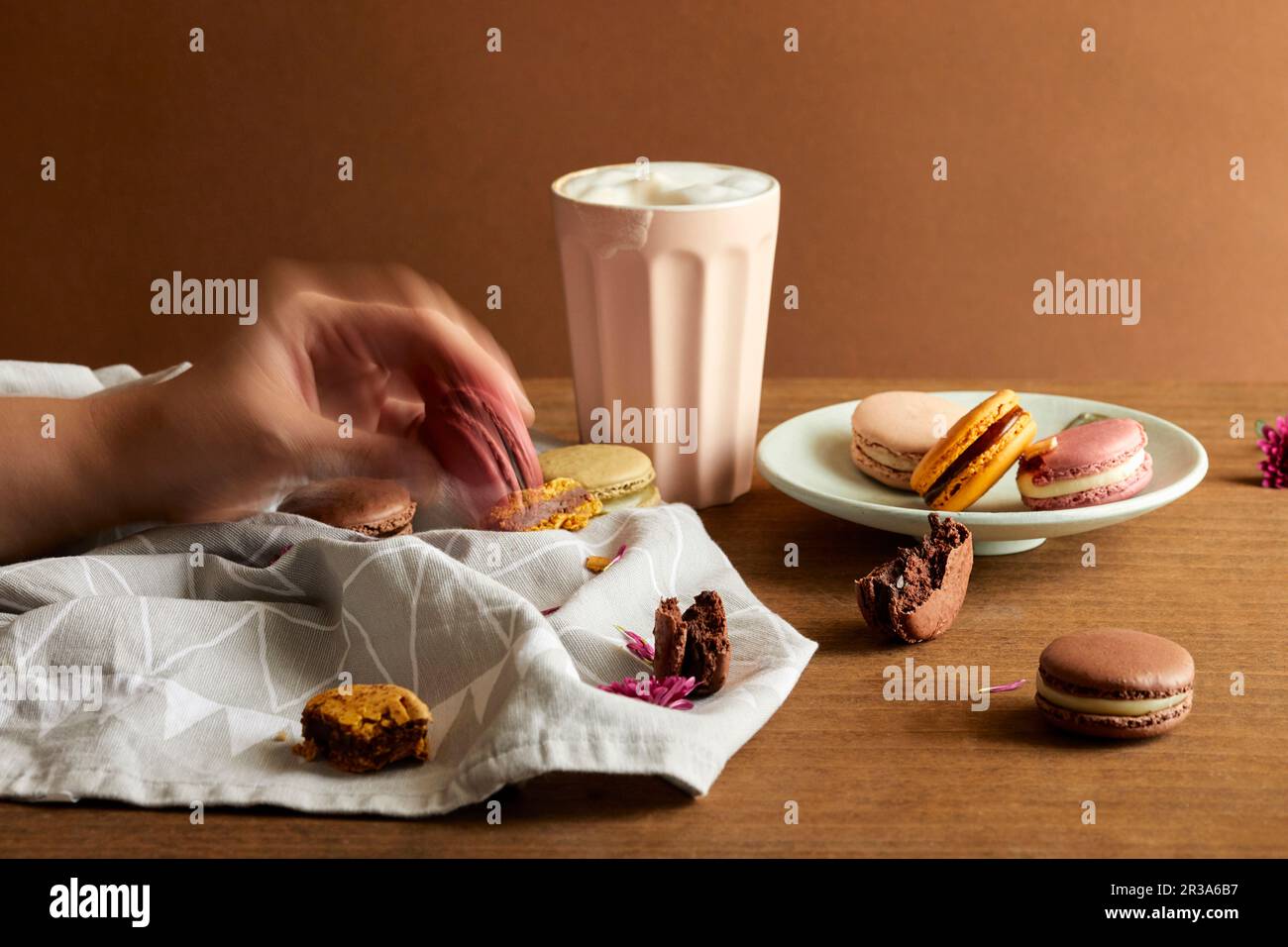 A hand taking macaron from a plate Stock Photo - Alamy