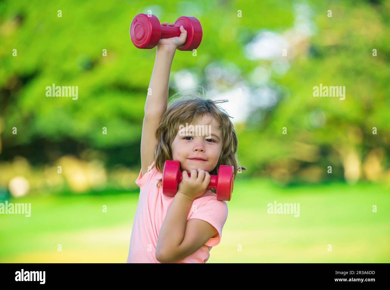 Sporty boy with dumbbells outdoor. Fitness kids, health and energy ...