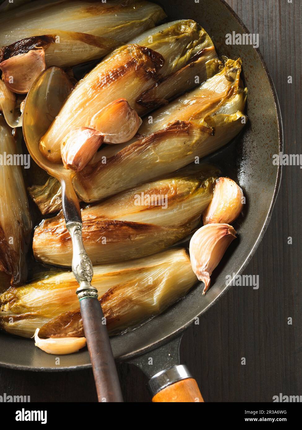 Roasted chicory with garlic Stock Photo - Alamy