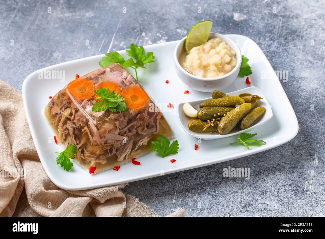 Aspic with pickled gherkin and horseradish sauce. Kholodets is a ...