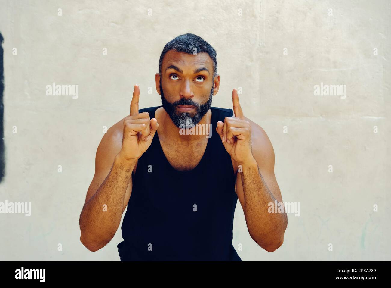 An African American man with a full beard and facial hair is looking up ...