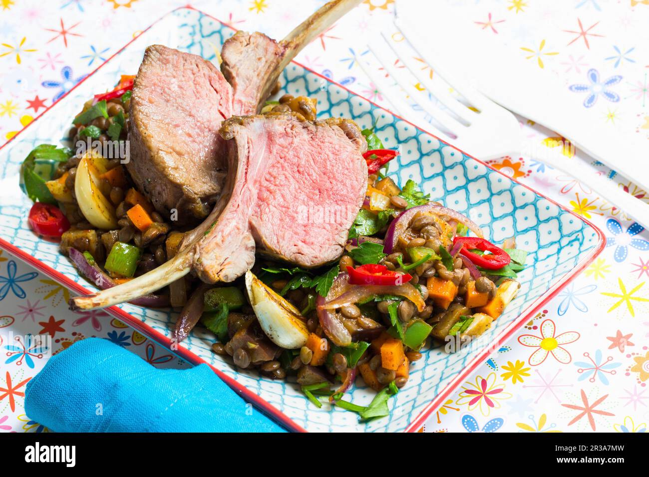 Rare lamb chops on a lentil medley with fresh chillis Stock Photo - Alamy