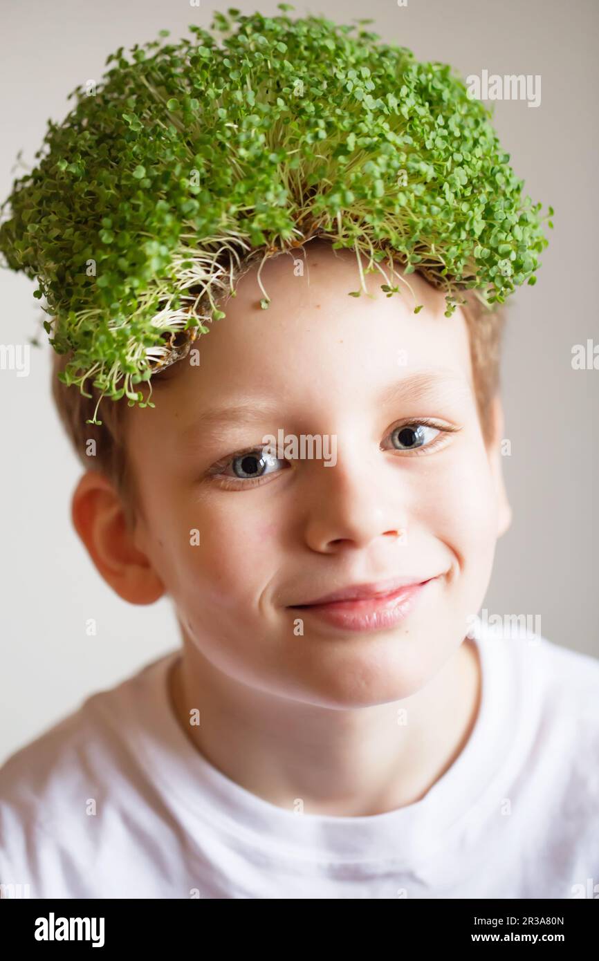 Kid with a microgreens hair. Healthy vegan foods concept. Cute little ...
