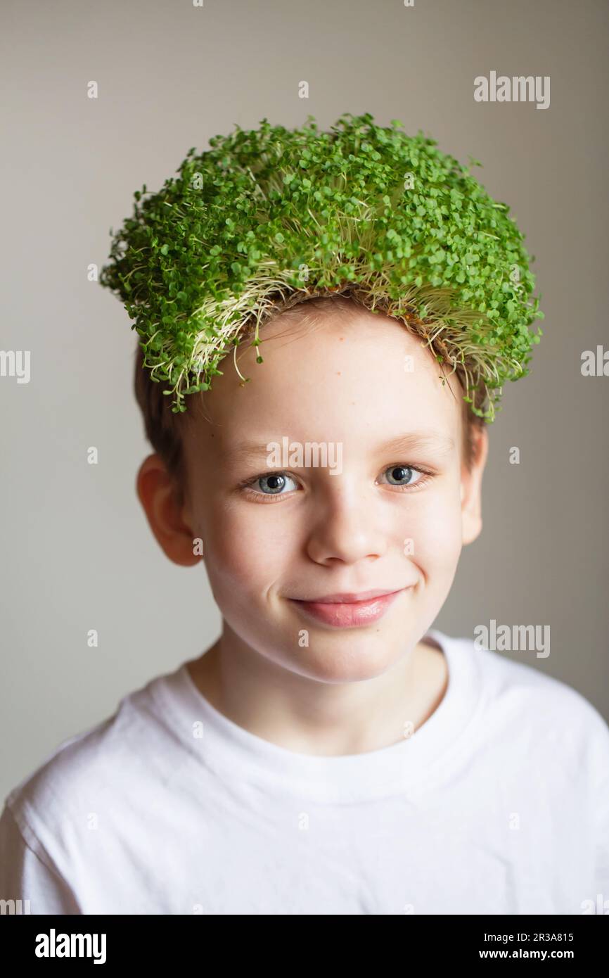Kid with a microgreens hair. Healthy vegan foods concept. Cute little ...