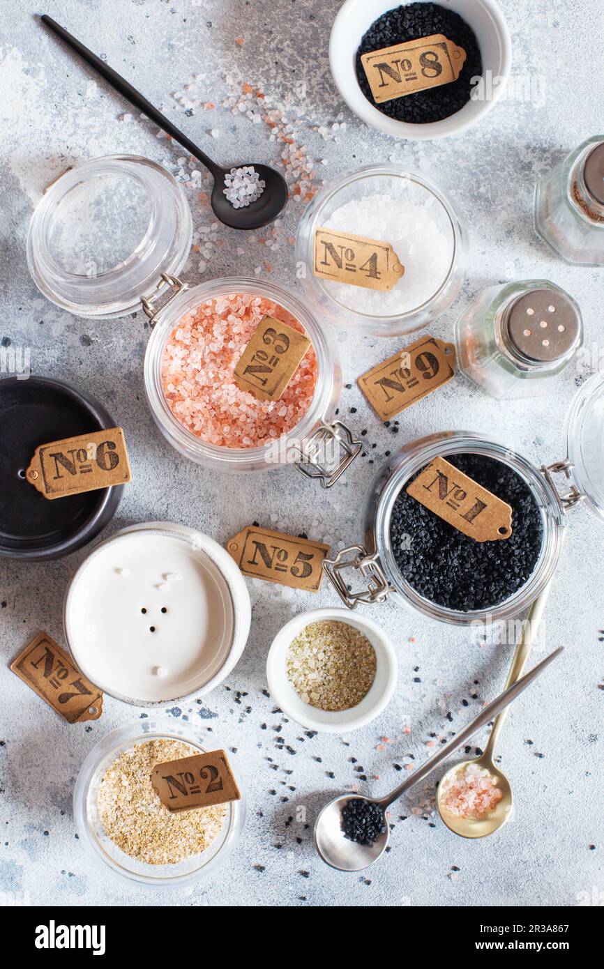 Mix of different salt types on grey concrete background. Sea salts ...