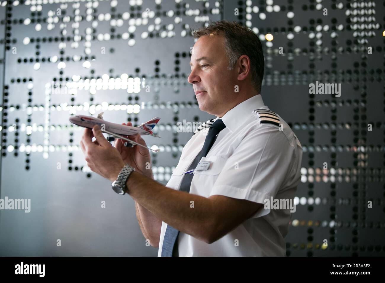 British Airways Captain Pilot holding a model Airbus A380 airplane ...