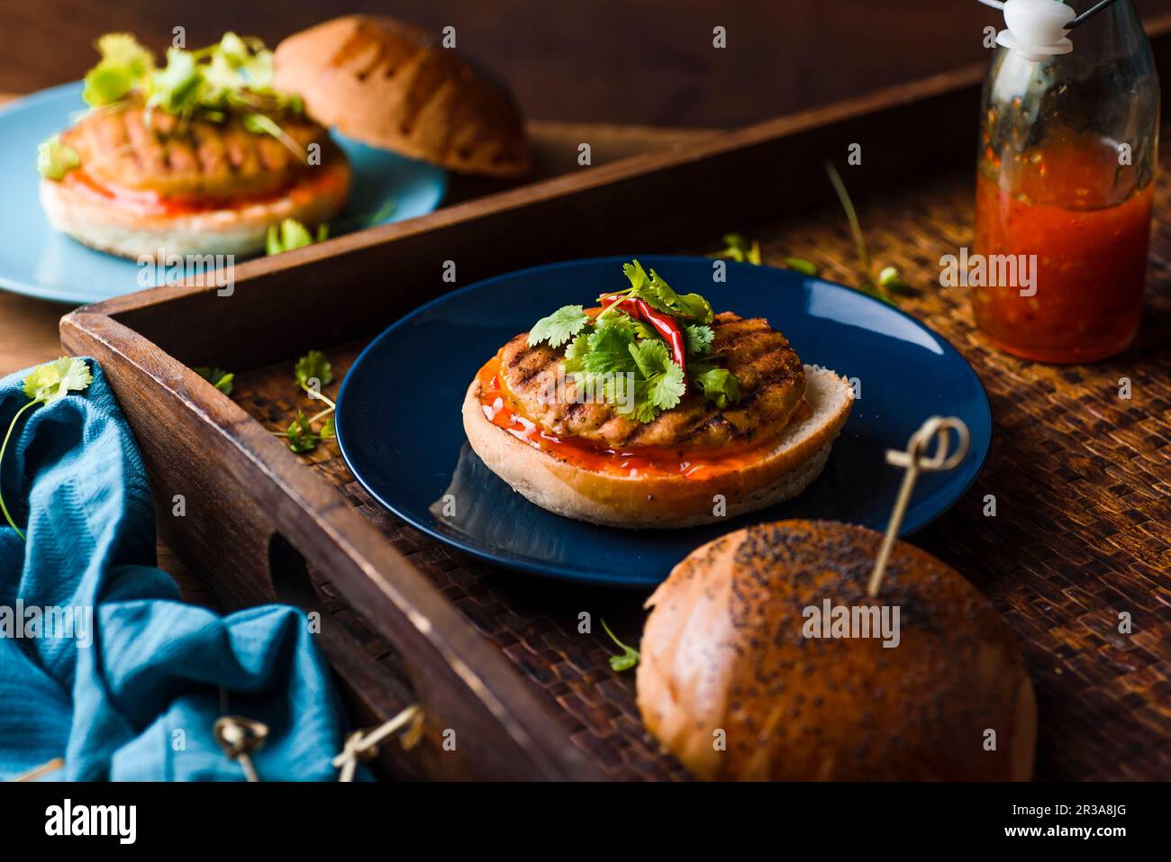 Curry chicken burger with sweet chilli sauce and fresh coriander Stock ...
