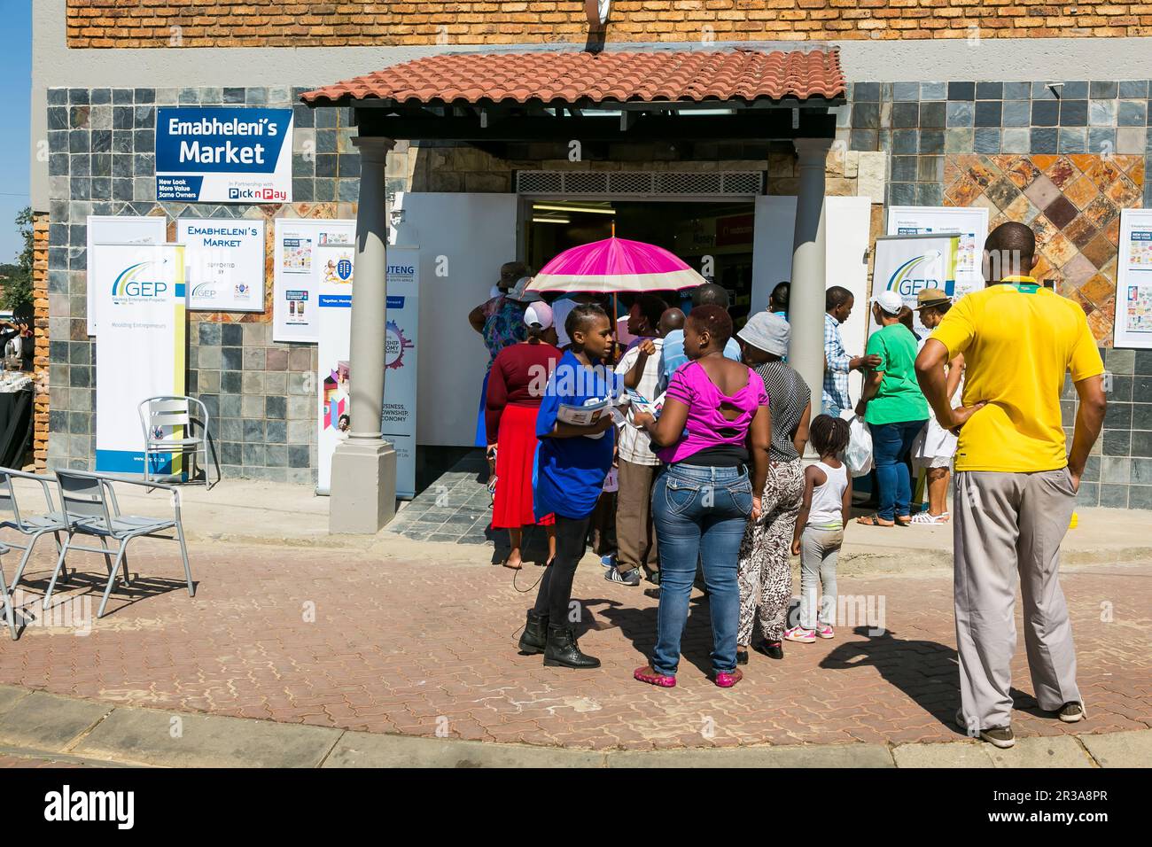 Customers waiting in line at entrance to local Pick n Pay grocery store ...