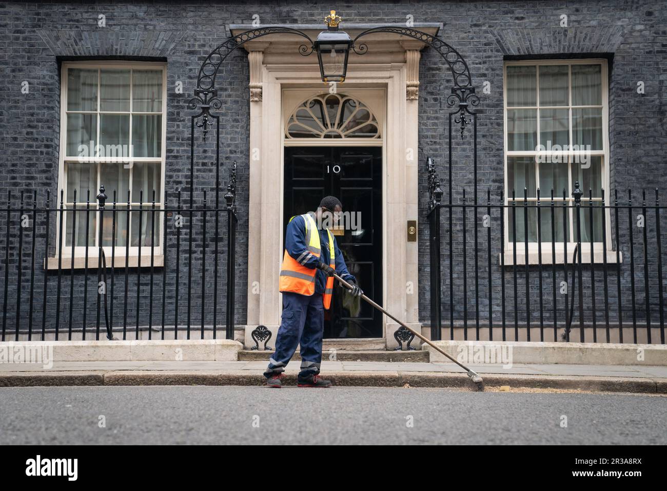 A street cleaner sweeps outside 10 Downing Street, London, before a ...
