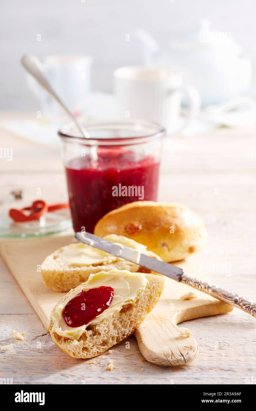 Sour cherry jam with raspberries on bread rolls with butter Stock Photo ...