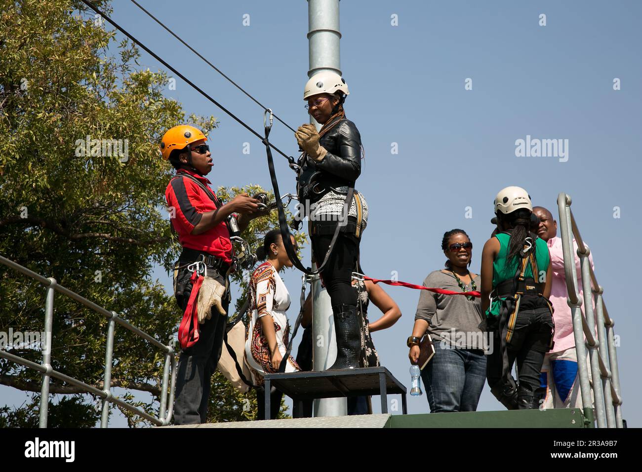 Diverse Adults having fun on a Zip Line ride in the countryside Stock ...