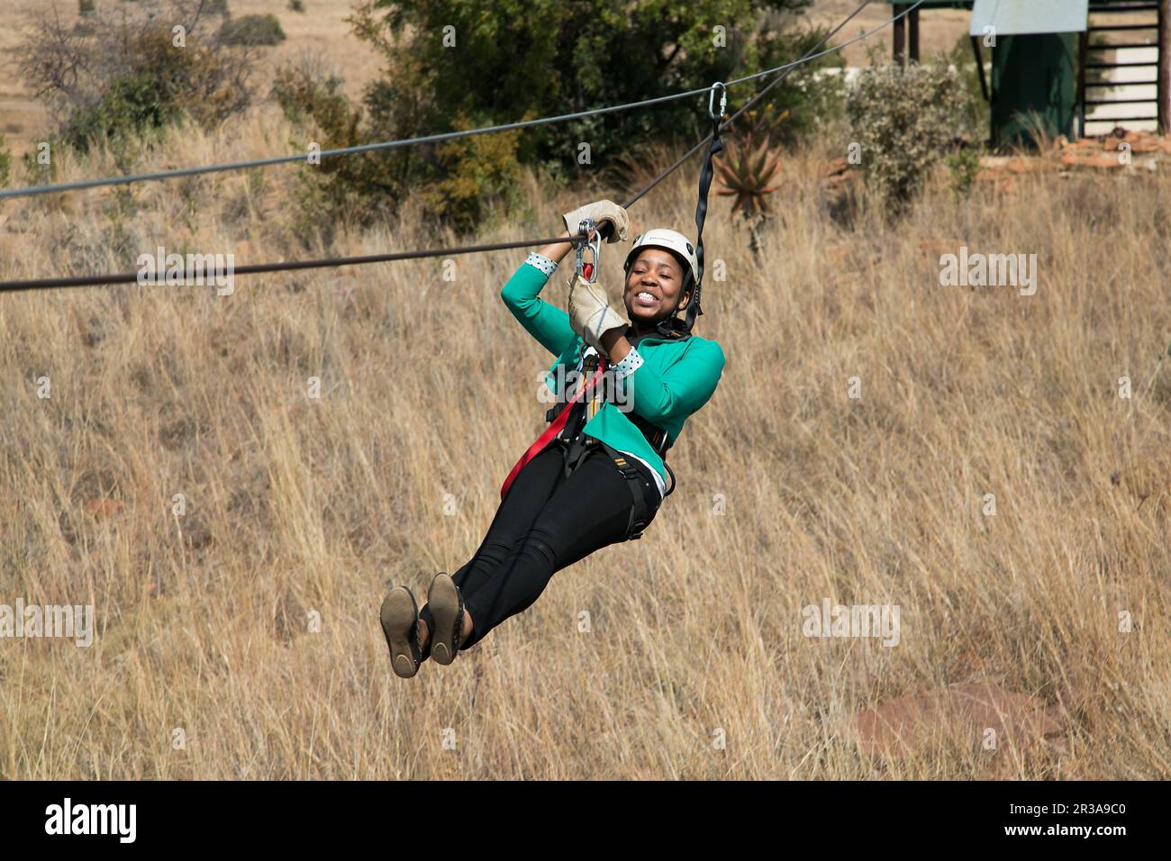 Diverse Adults having fun on a Zip Line ride in the countryside Stock ...
