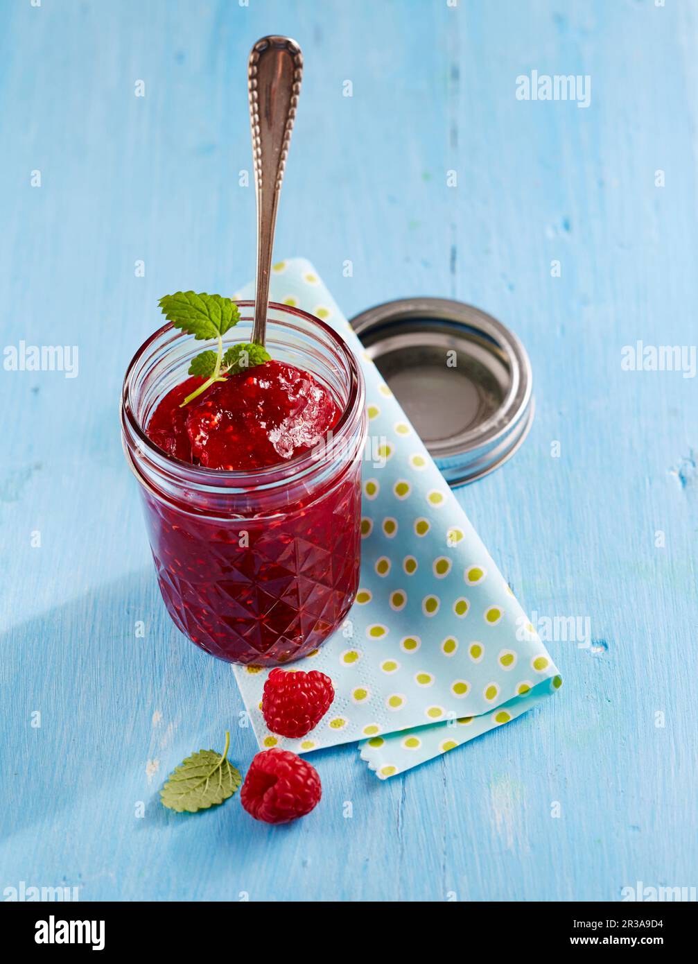 A jar of mango and raspberry jam with fresh lemon balm Stock Photo - Alamy